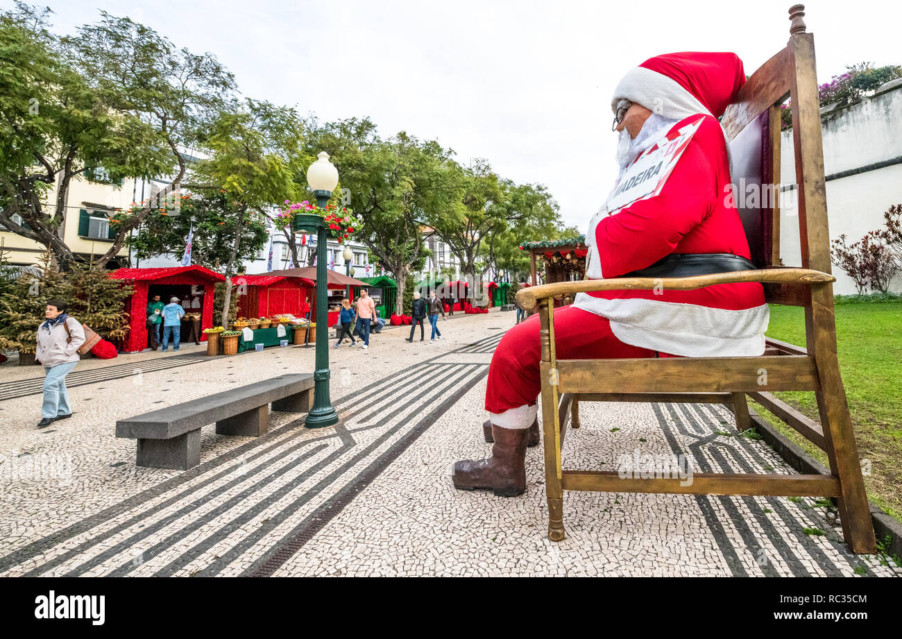 Large figure of Santa Claus or Father Christmas sat on a chair as a ...