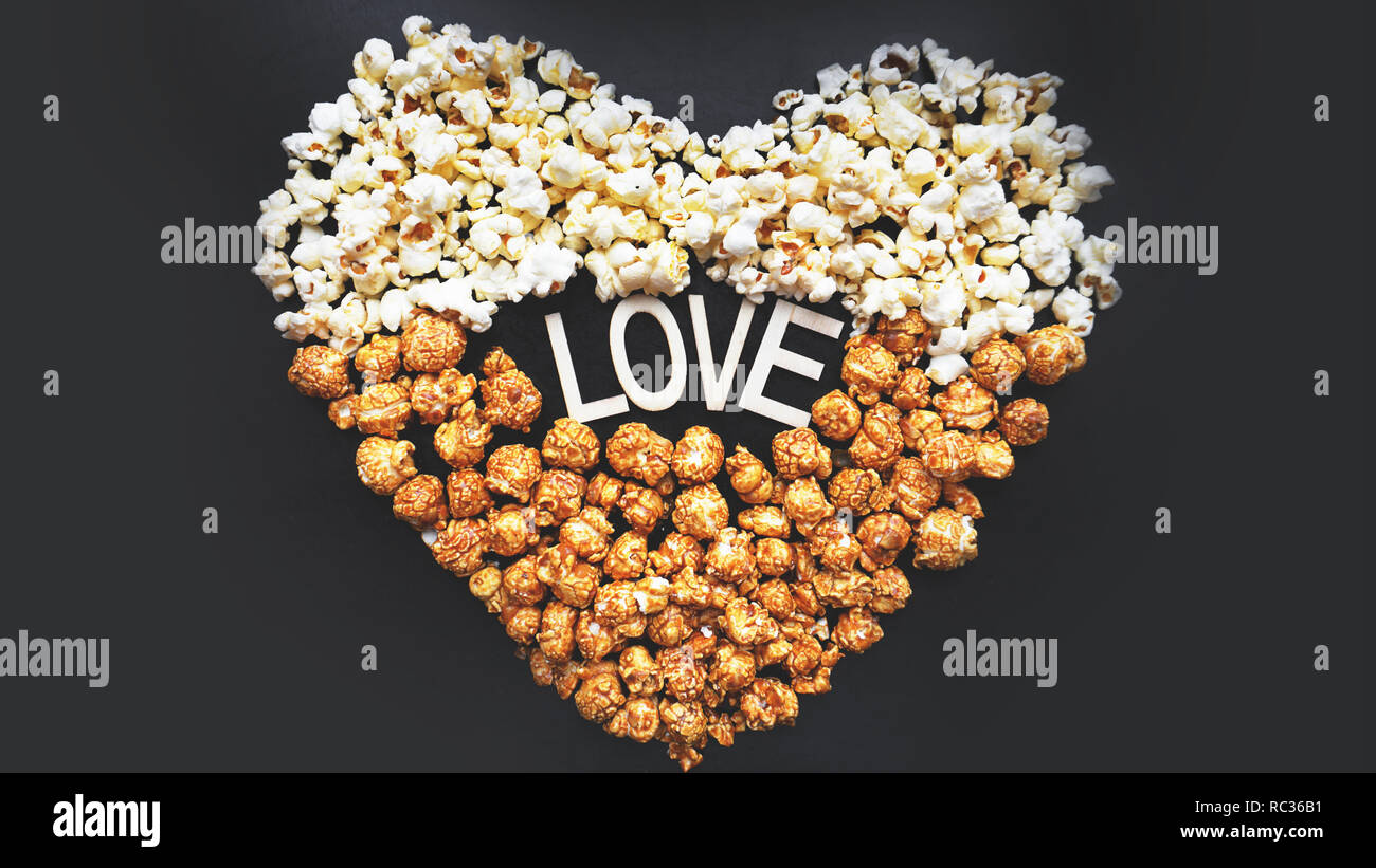 Love Cinema concept of popcorn arranged in a heart shape. Assorted ...