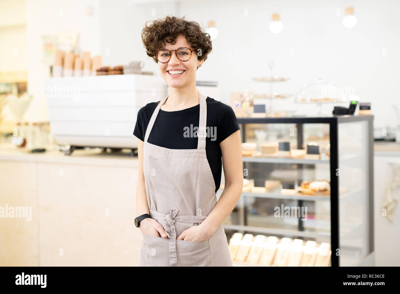 Cheerful lady barista Stock Photo - Alamy