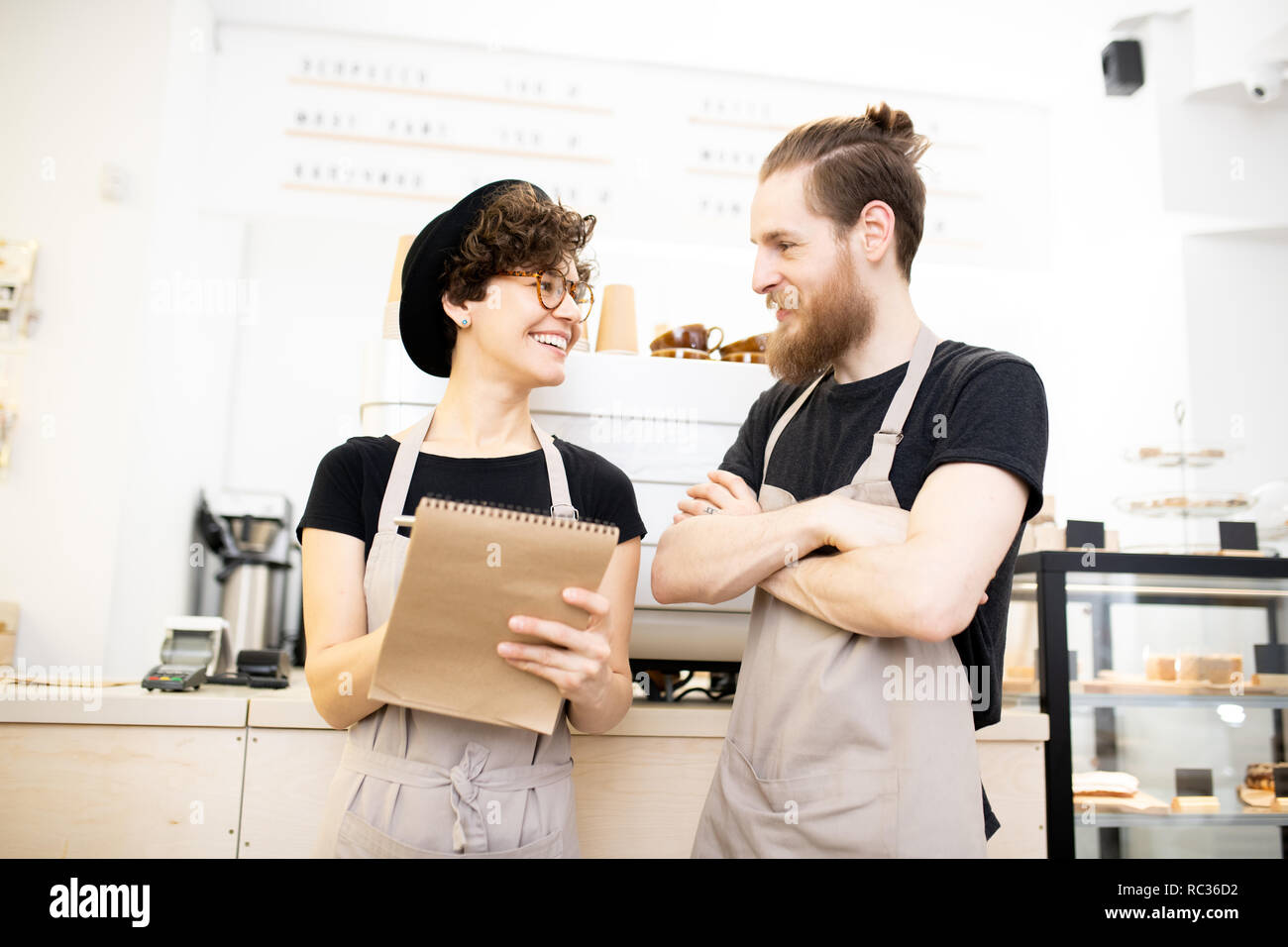 Positive coffee shop colleagues chatting Stock Photo - Alamy