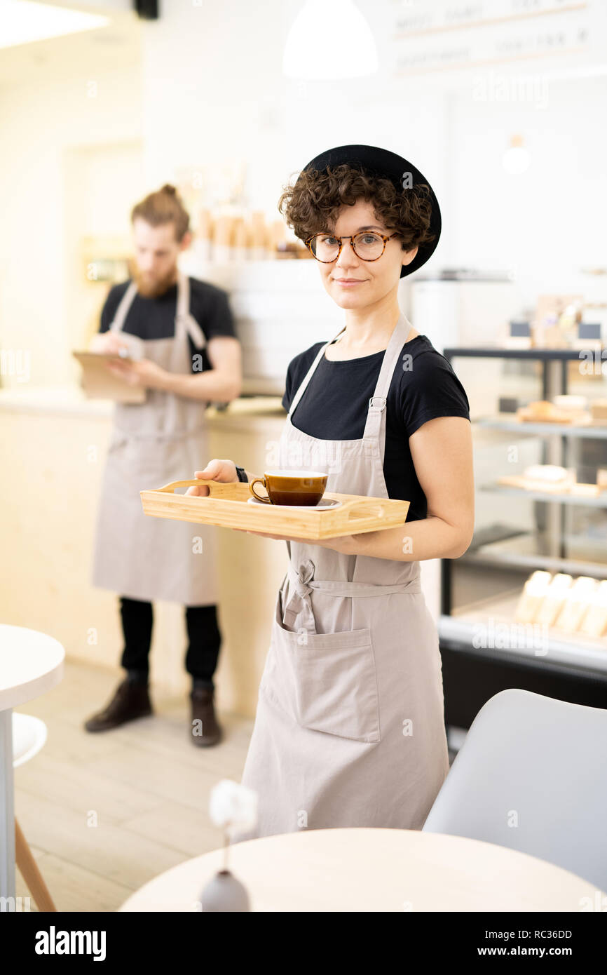 Young woman carrying tray hi-res stock photography and images - Alamy