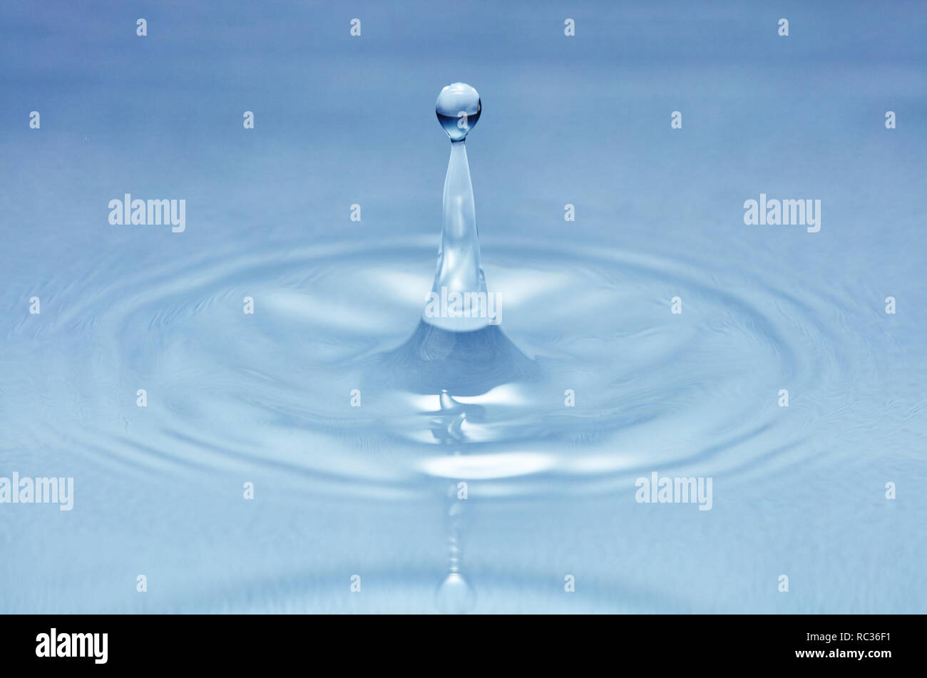 droplet splash on blue water surface Stock Photo - Alamy