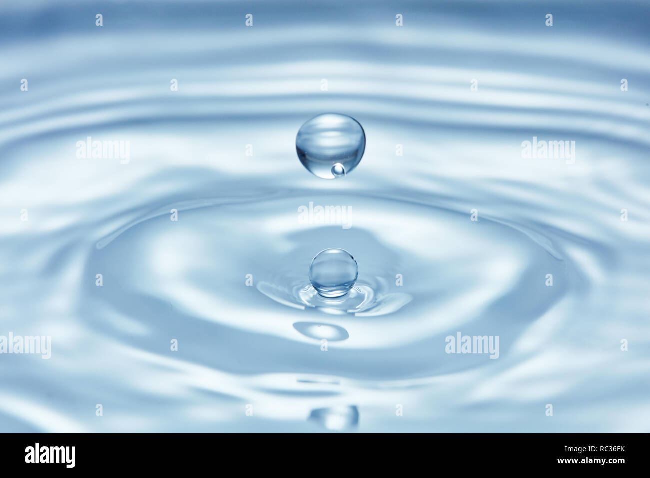 droplet splash on blue water surface Stock Photo - Alamy