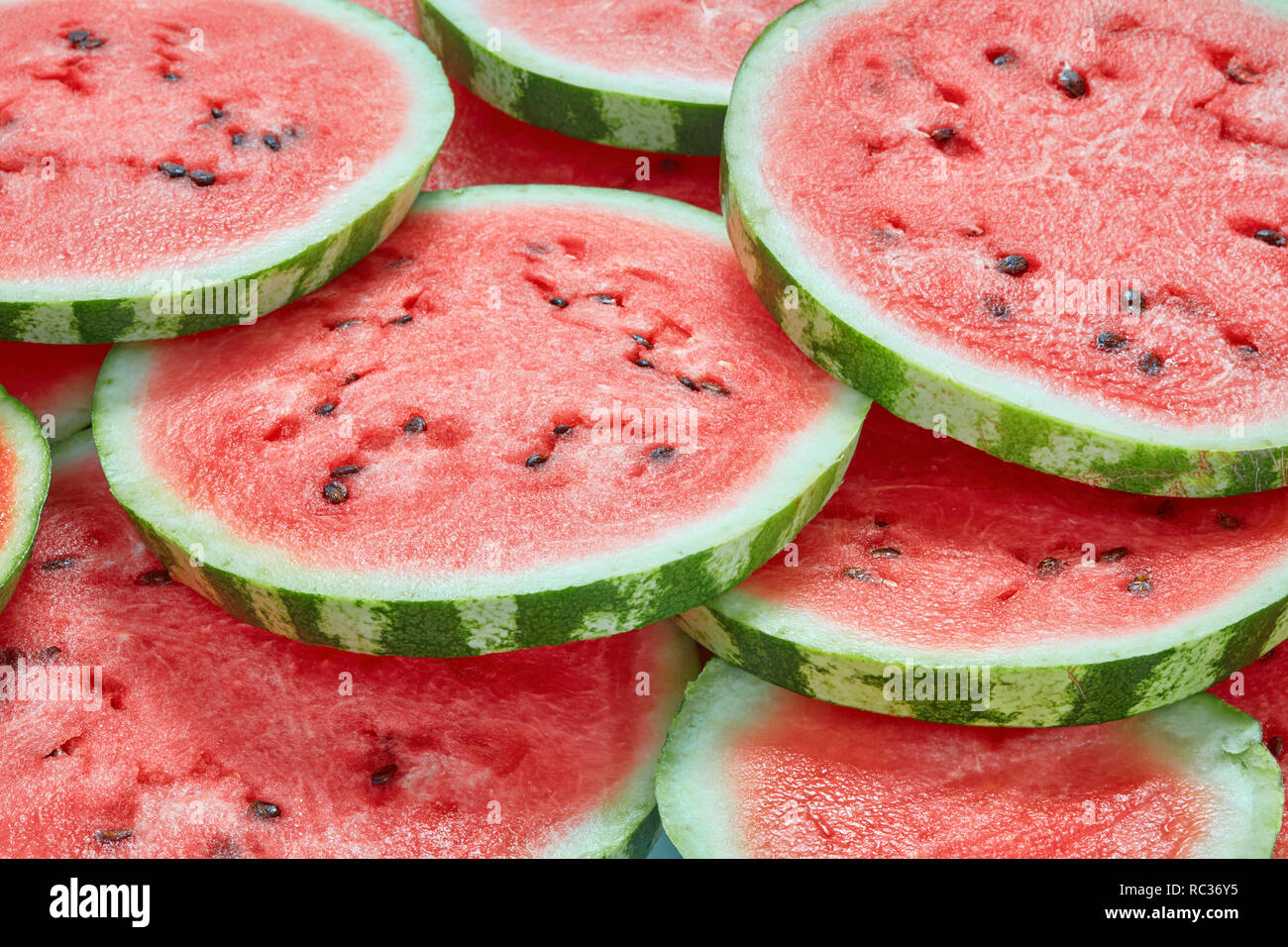 heap of ripe red watermelon slices as textured background Stock Photo ...