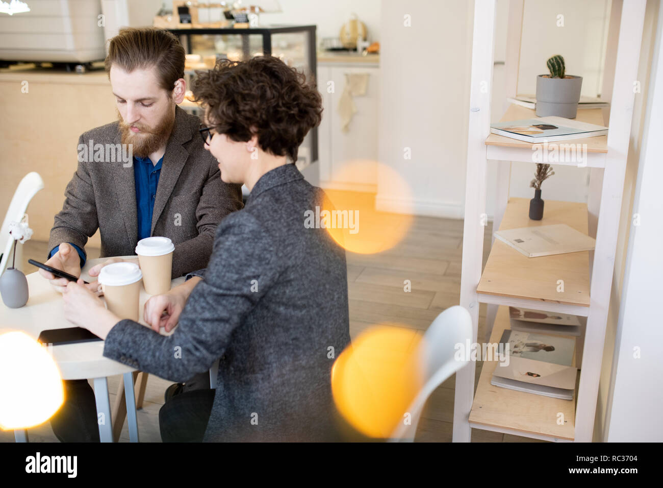 Young couple having coffee break in cafe Stock Photo - Alamy