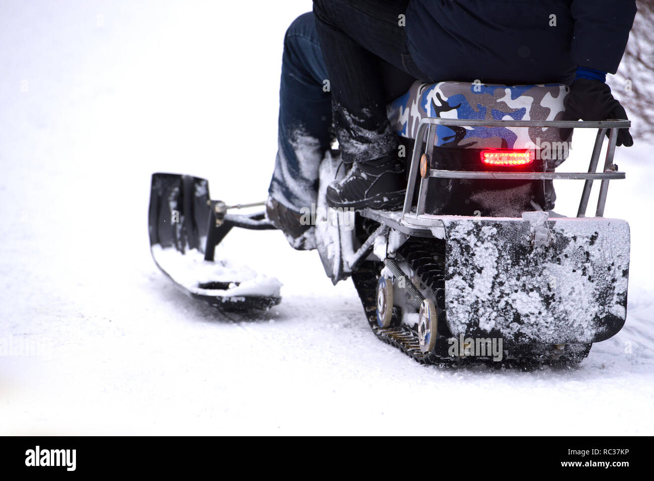 People riding a snowmobile action Stock Photo - Alamy