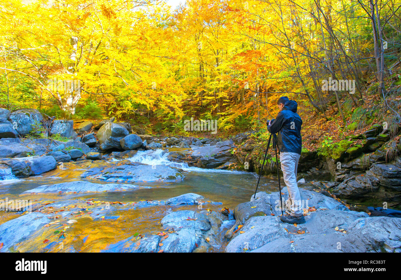 Landscape photographer taking pictures in autumn season Stock Photo - Alamy