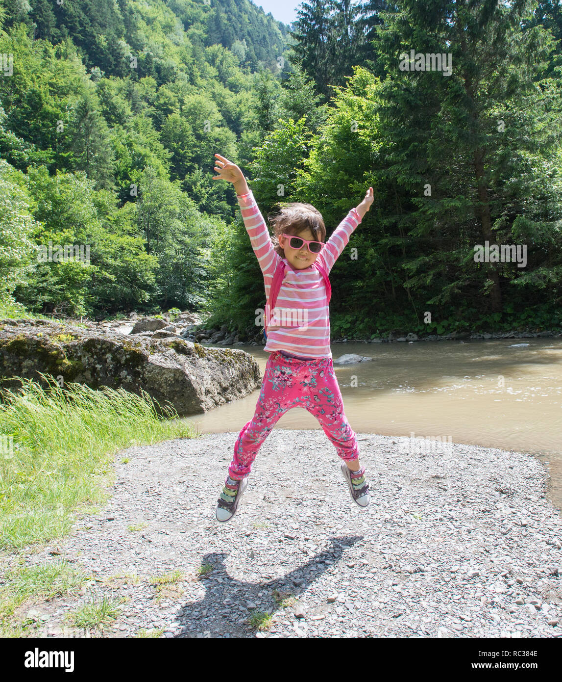 little girl jumping in the nature Stock Photo - Alamy