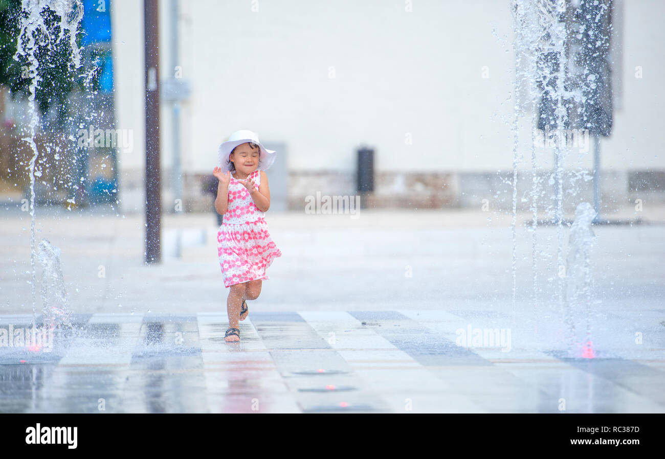 Girl running water fountain hi-res stock photography and images - Alamy