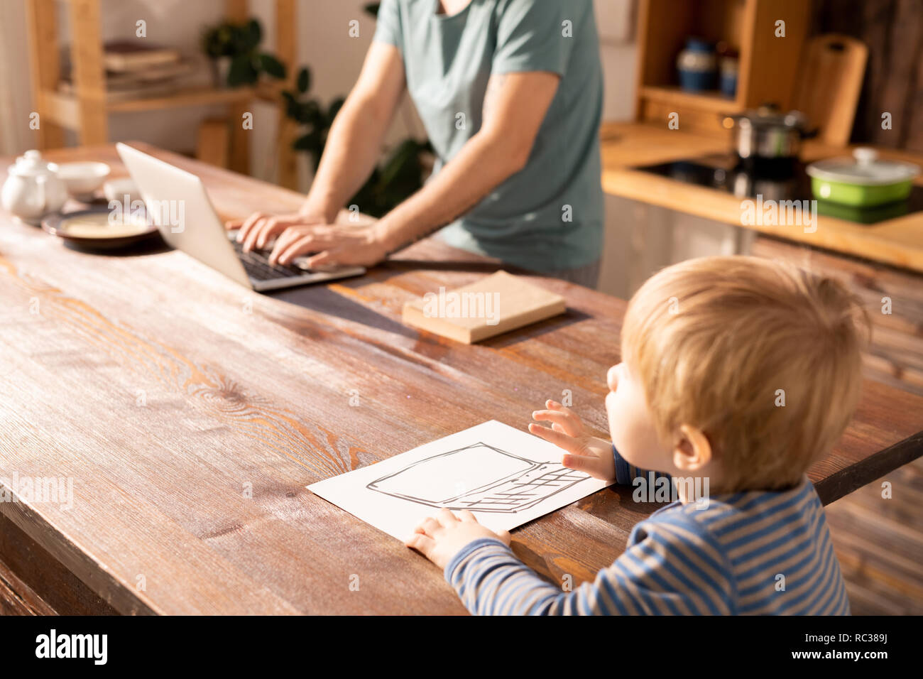 Little boy typing on drawn laptop Stock Photo - Alamy
