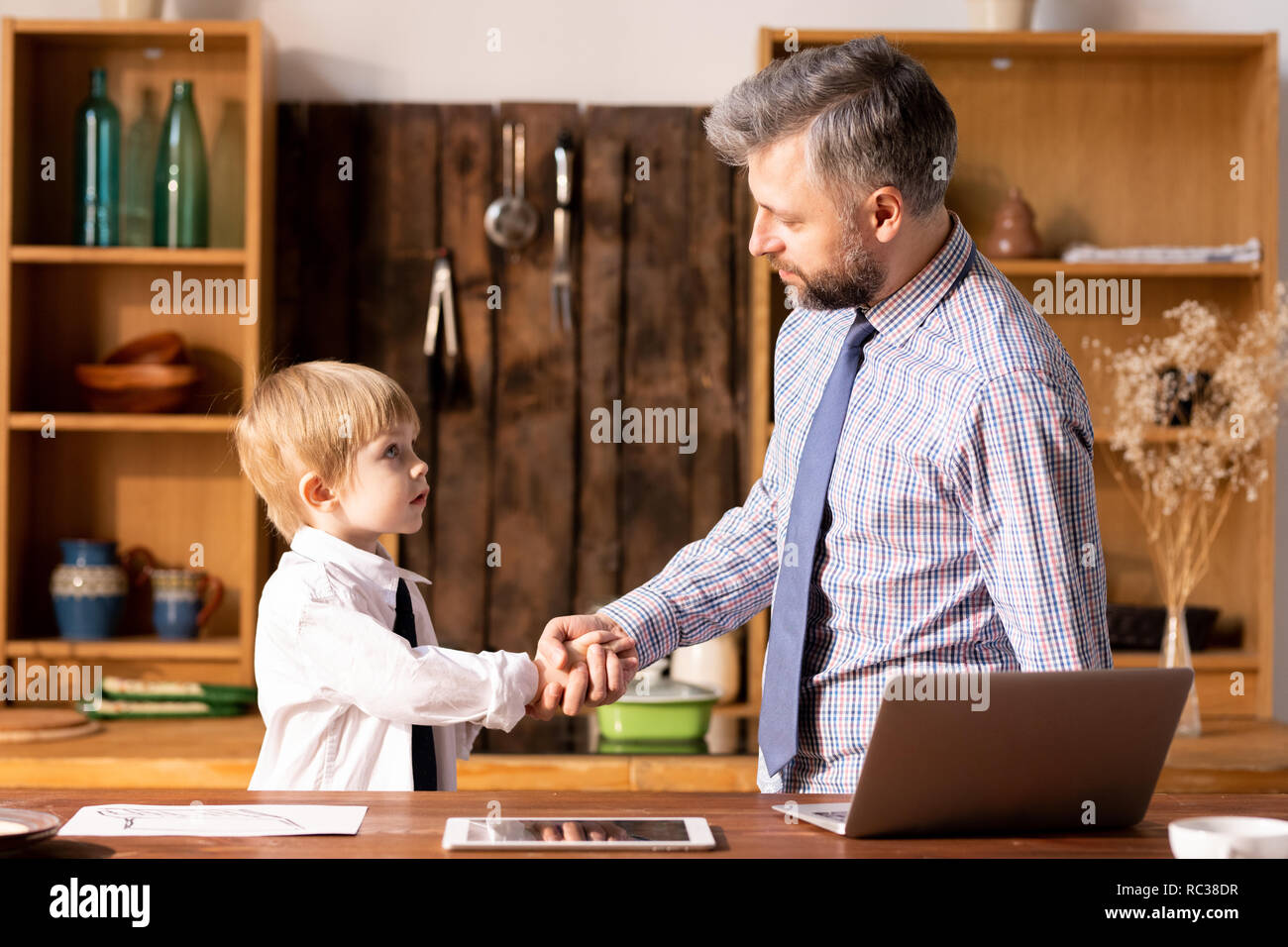 Father making handshake with little son in formal shirt Stock Photo - Alamy