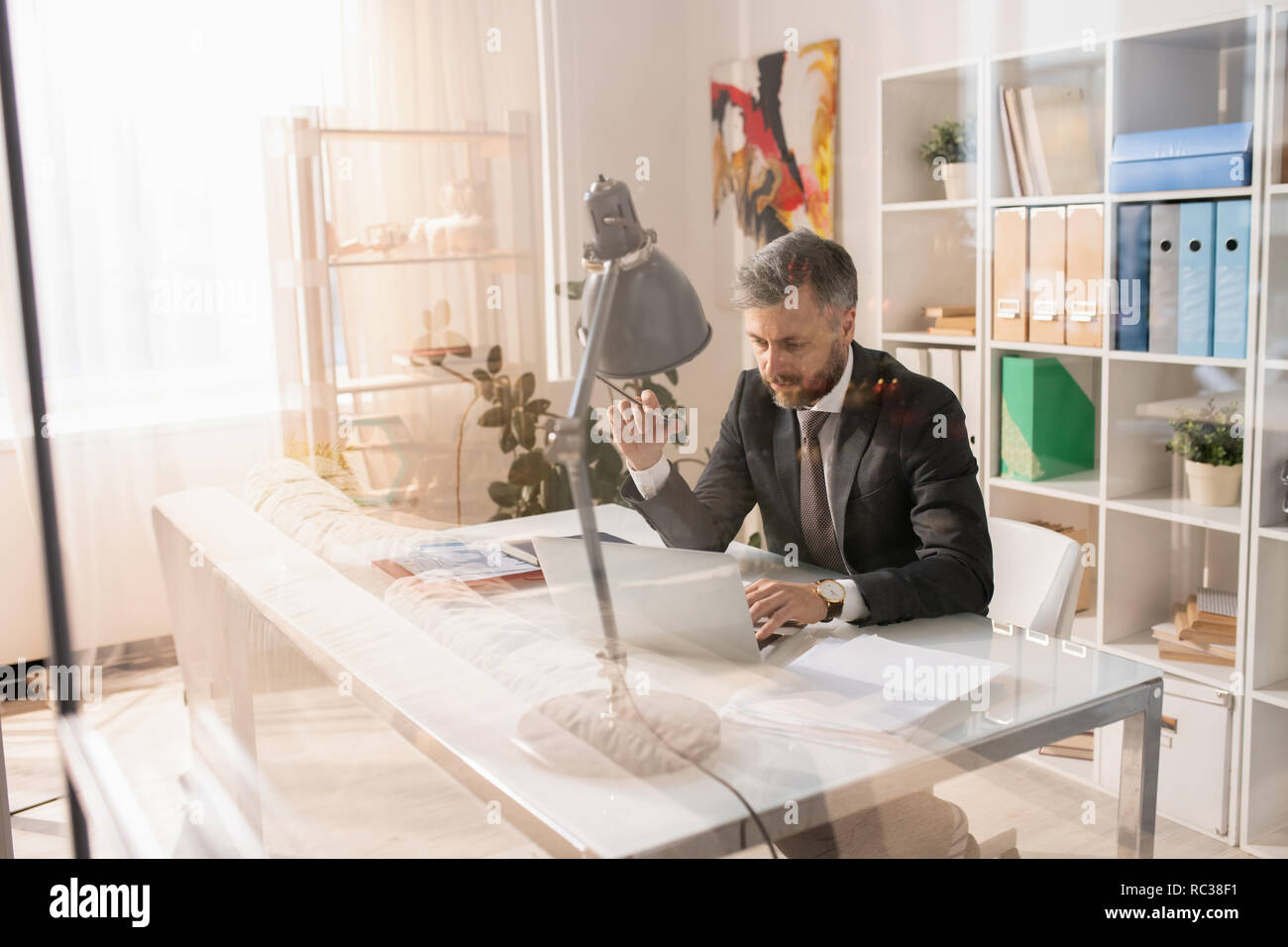 Serious office manager checking online files Stock Photo - Alamy