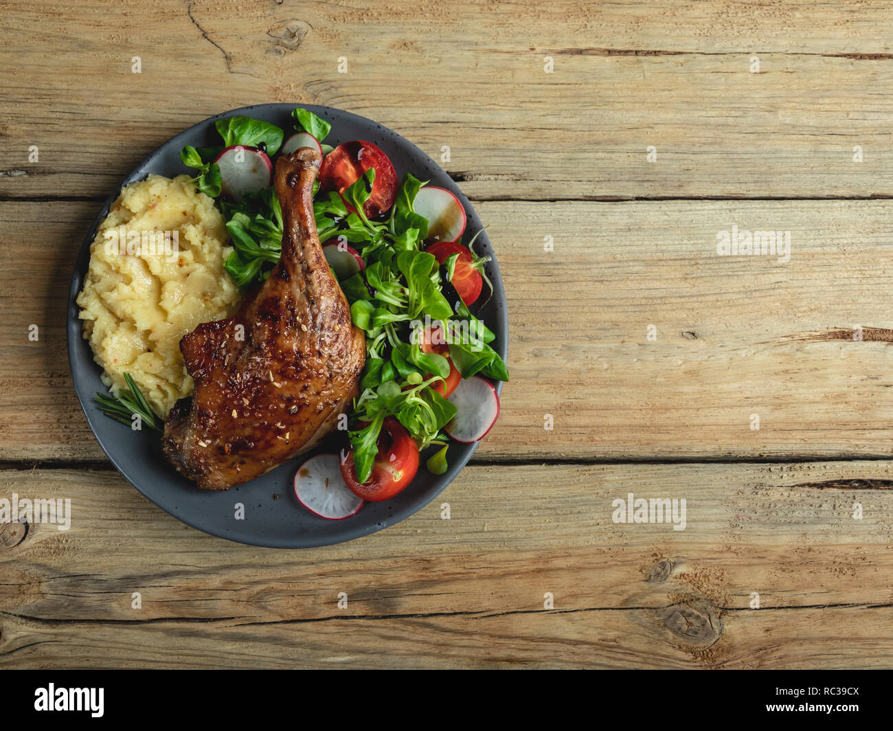 Roasted duck leg with tomato, herbs ,mashed potatoes in a plate Stock ...