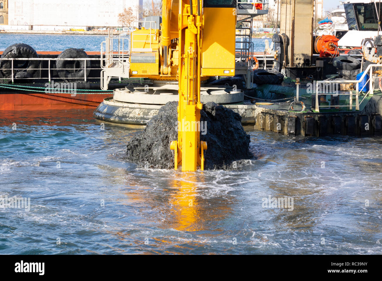 Canals being dredged. Excavator dredges a canal in the city Stock Photo ...
