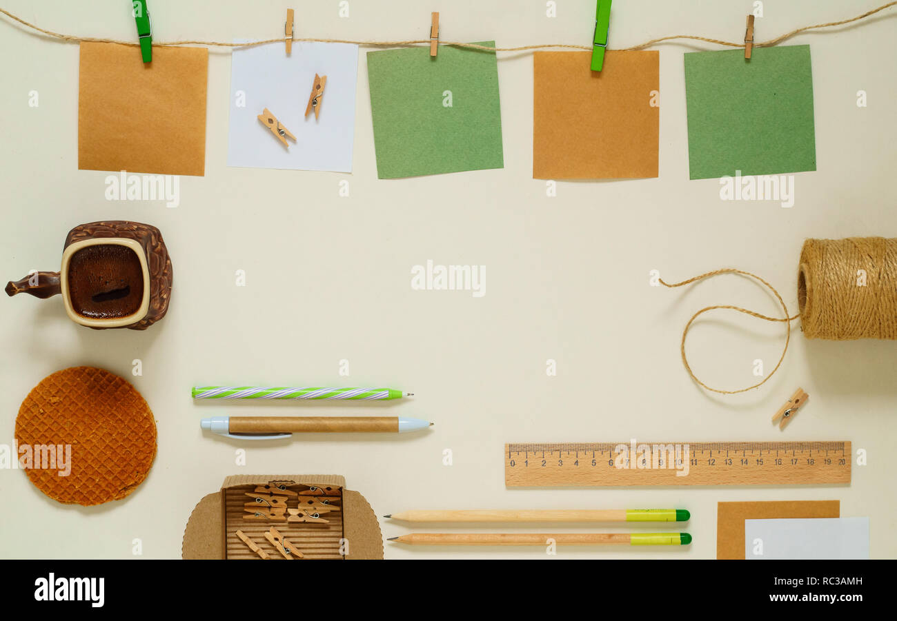 Flat lay of kraft paper stickers with clothespins, coffee and ...