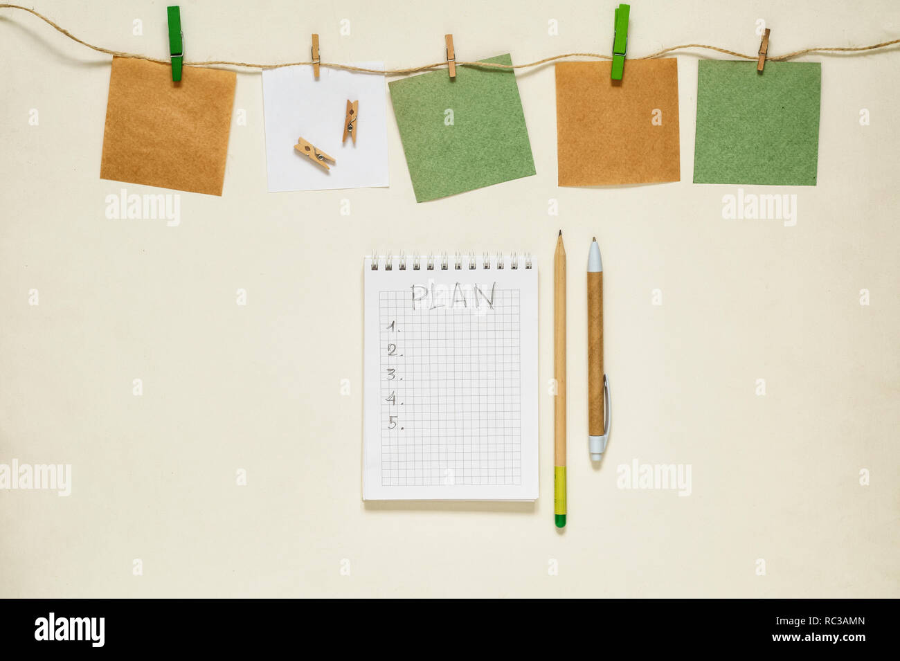 Word Plan on the notebook and kraft paper stickers with clothespins on ...