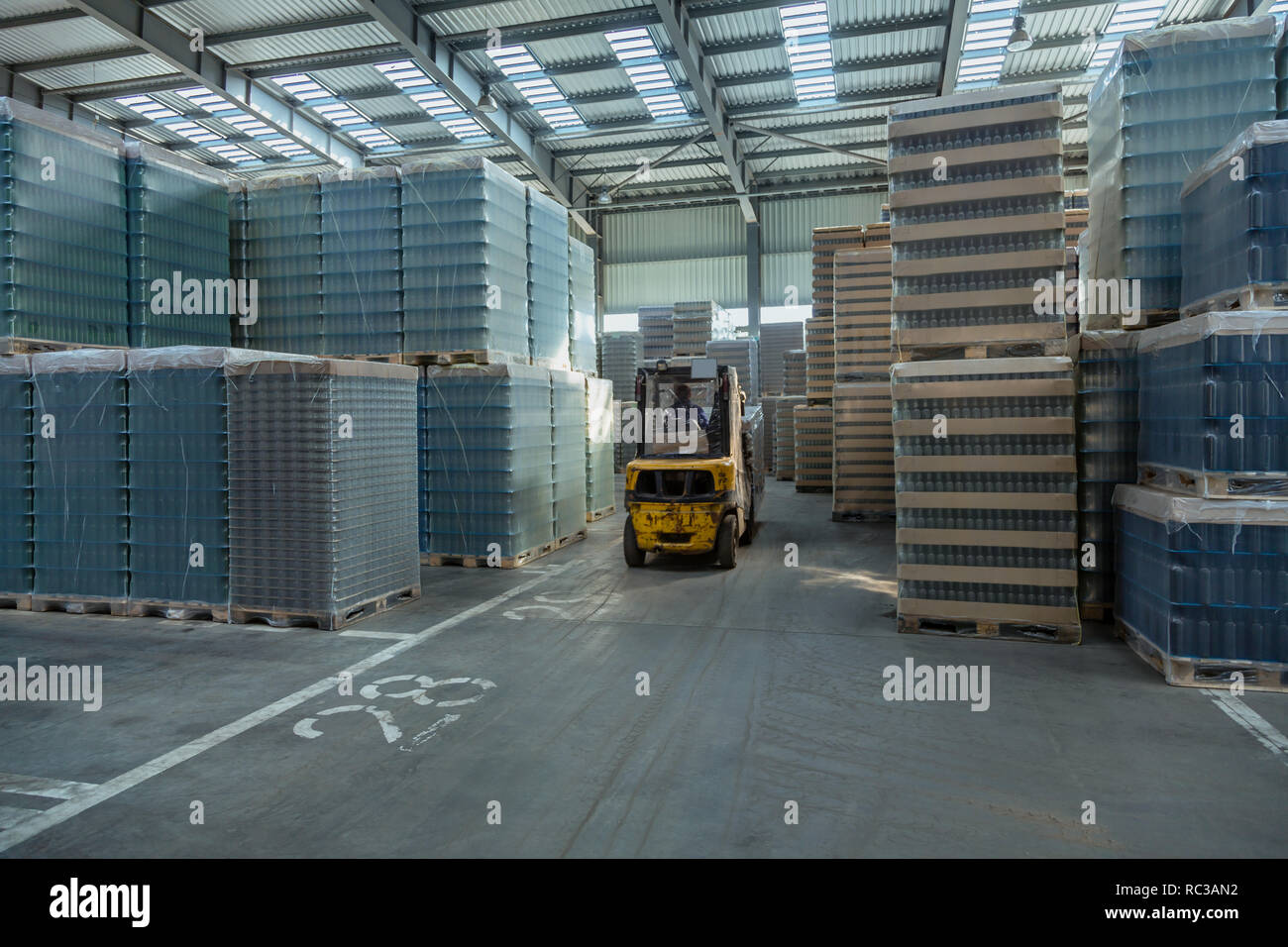 Large modern warehouse with forklifts Stock Photo - Alamy