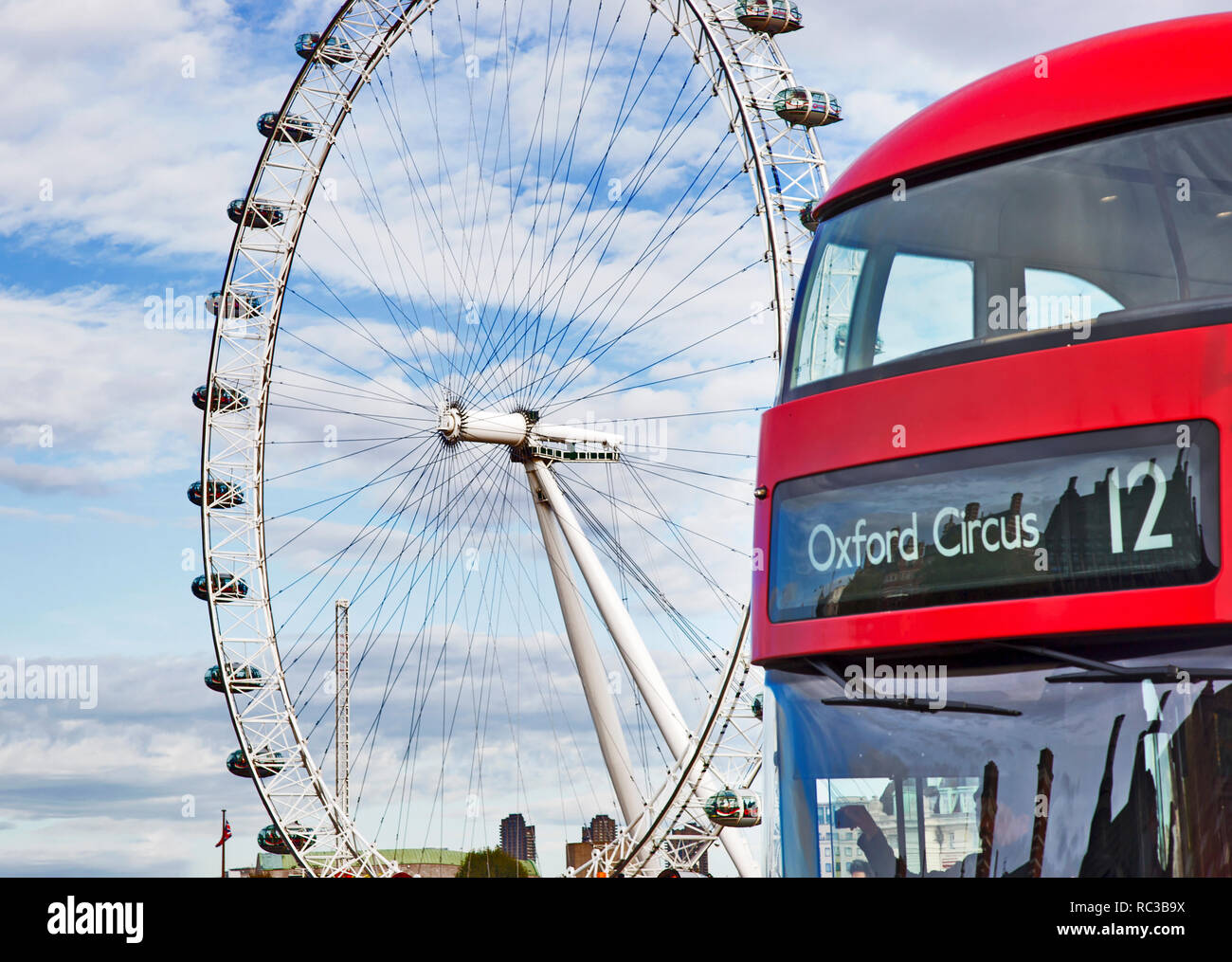 red bus crossing the Westminster bridge at London city and the huge ...