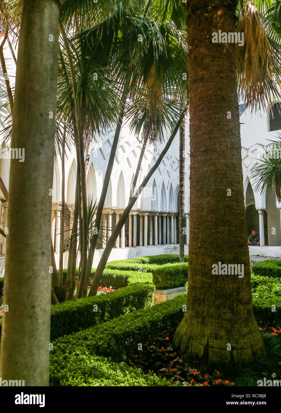 "Paradise Yard" is patio with gallery with pointed carved arches ...