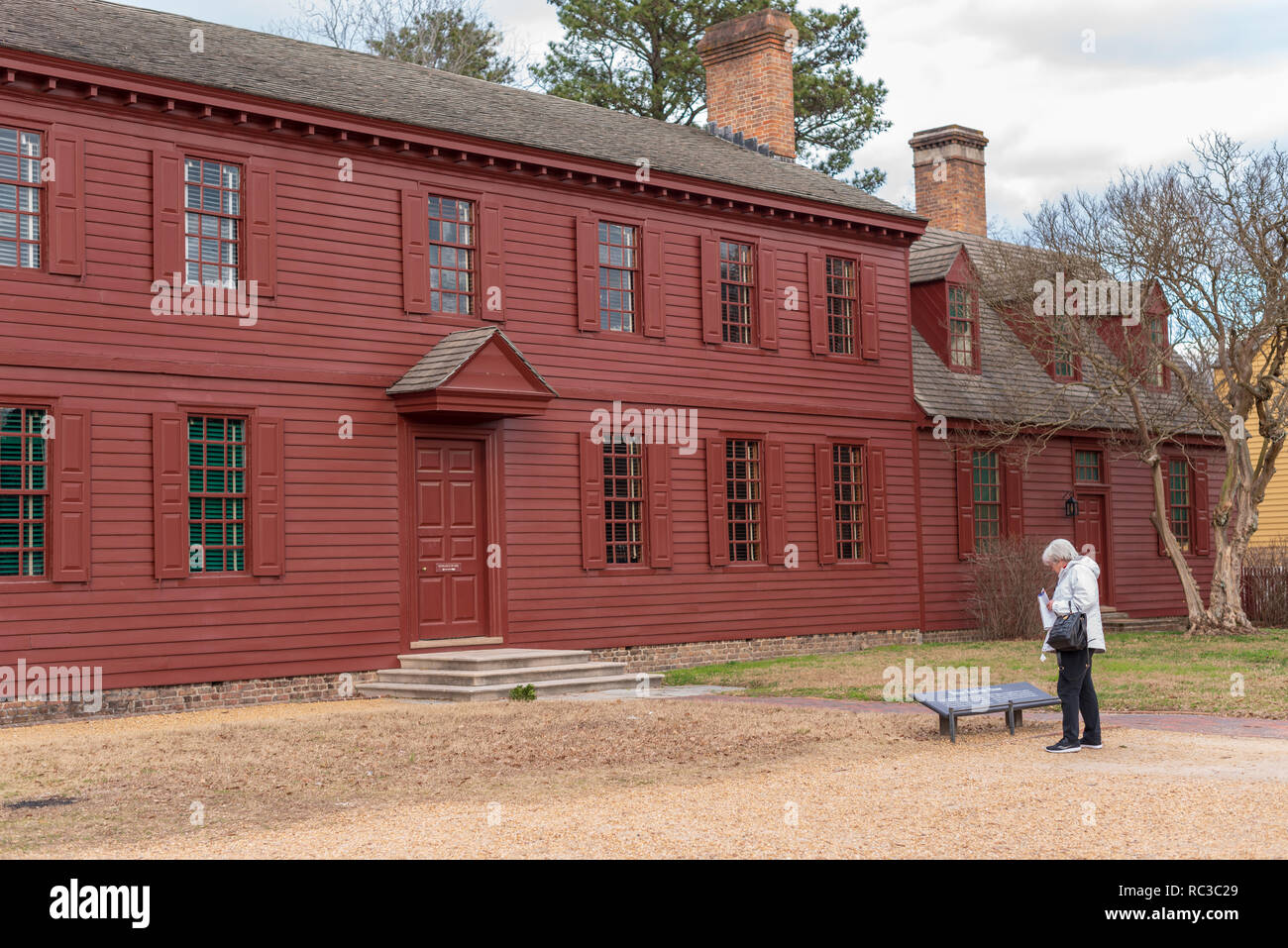 Williamsburg, VA, USA -- January 9, 2019. A tourist examines a sign ...