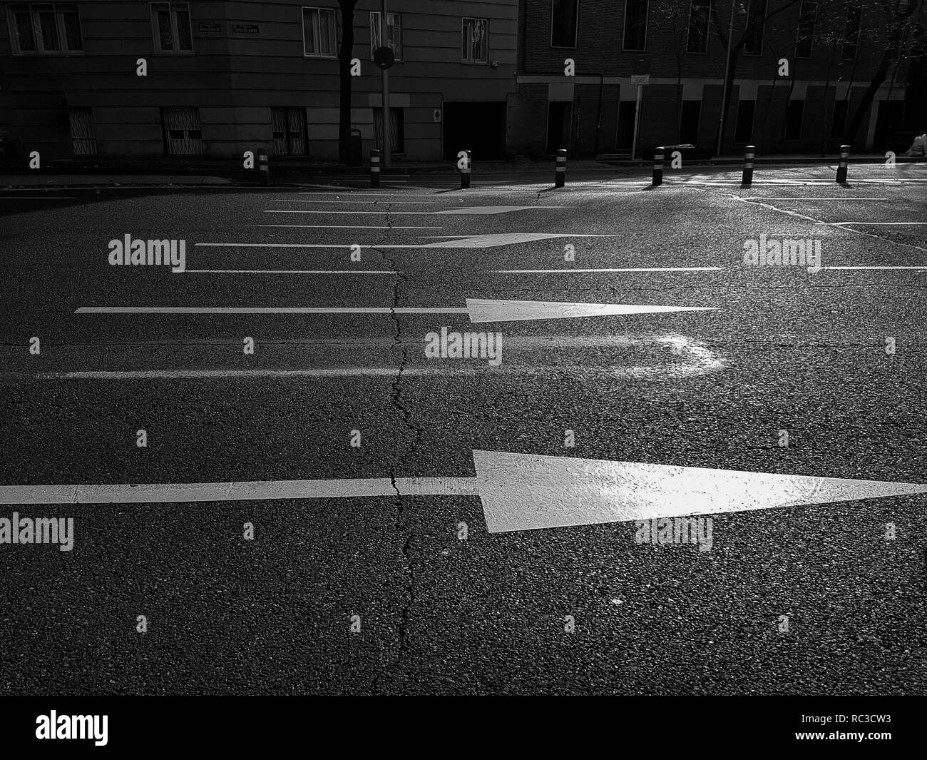 large white arrow signs drawn on the asphalt in the city Stock Photo ...