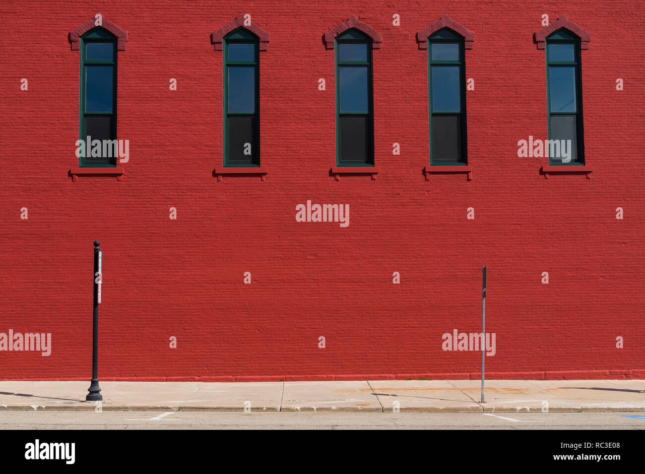 Red painted brick wall with windows Stock Photo - Alamy