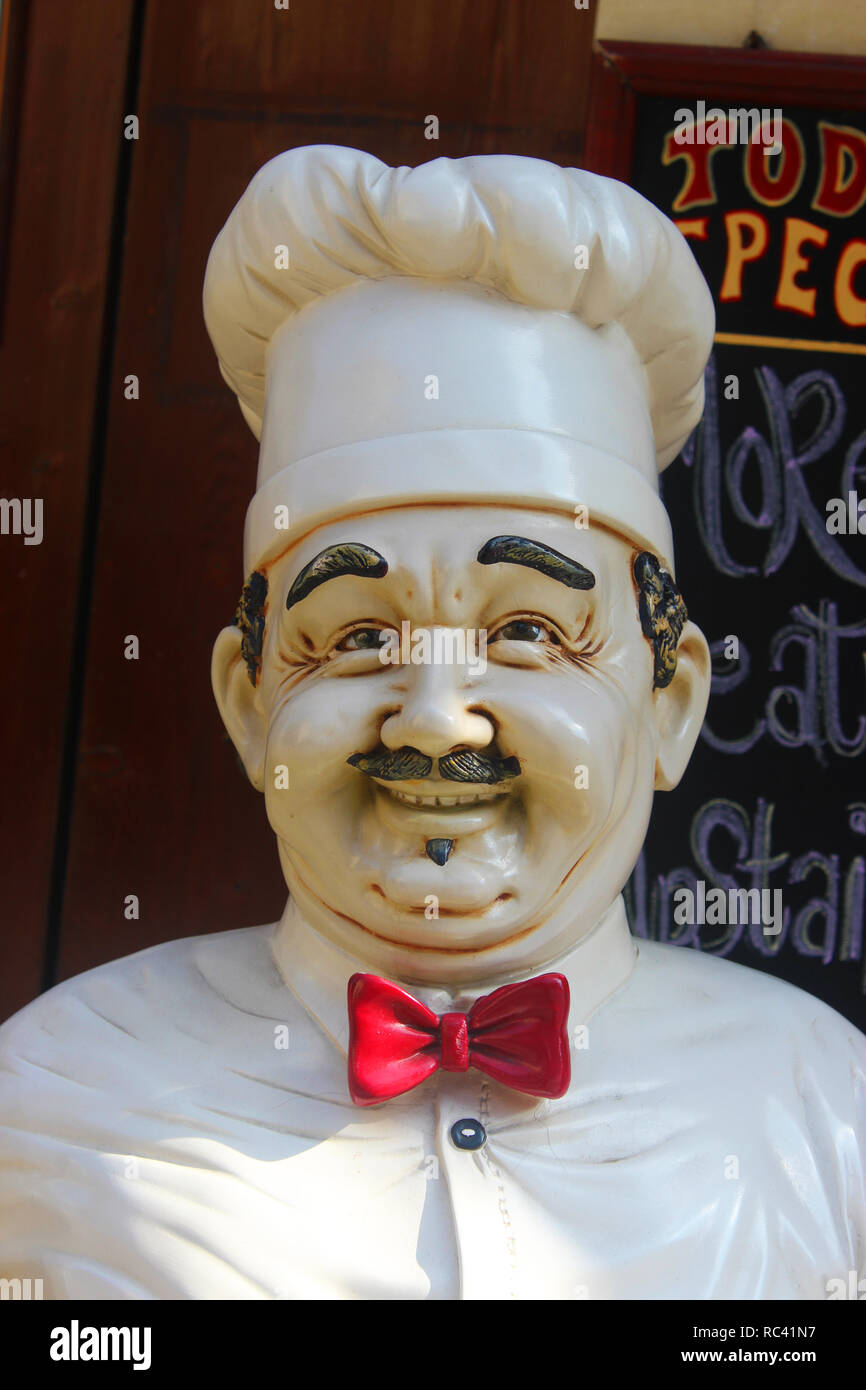 plastic figure of a cook or chef de cuisine, standing in front of a ...