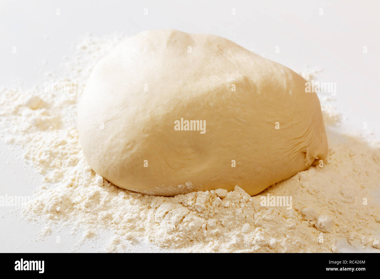 Raw fresh dough in flour on a white background Stock Photo - Alamy
