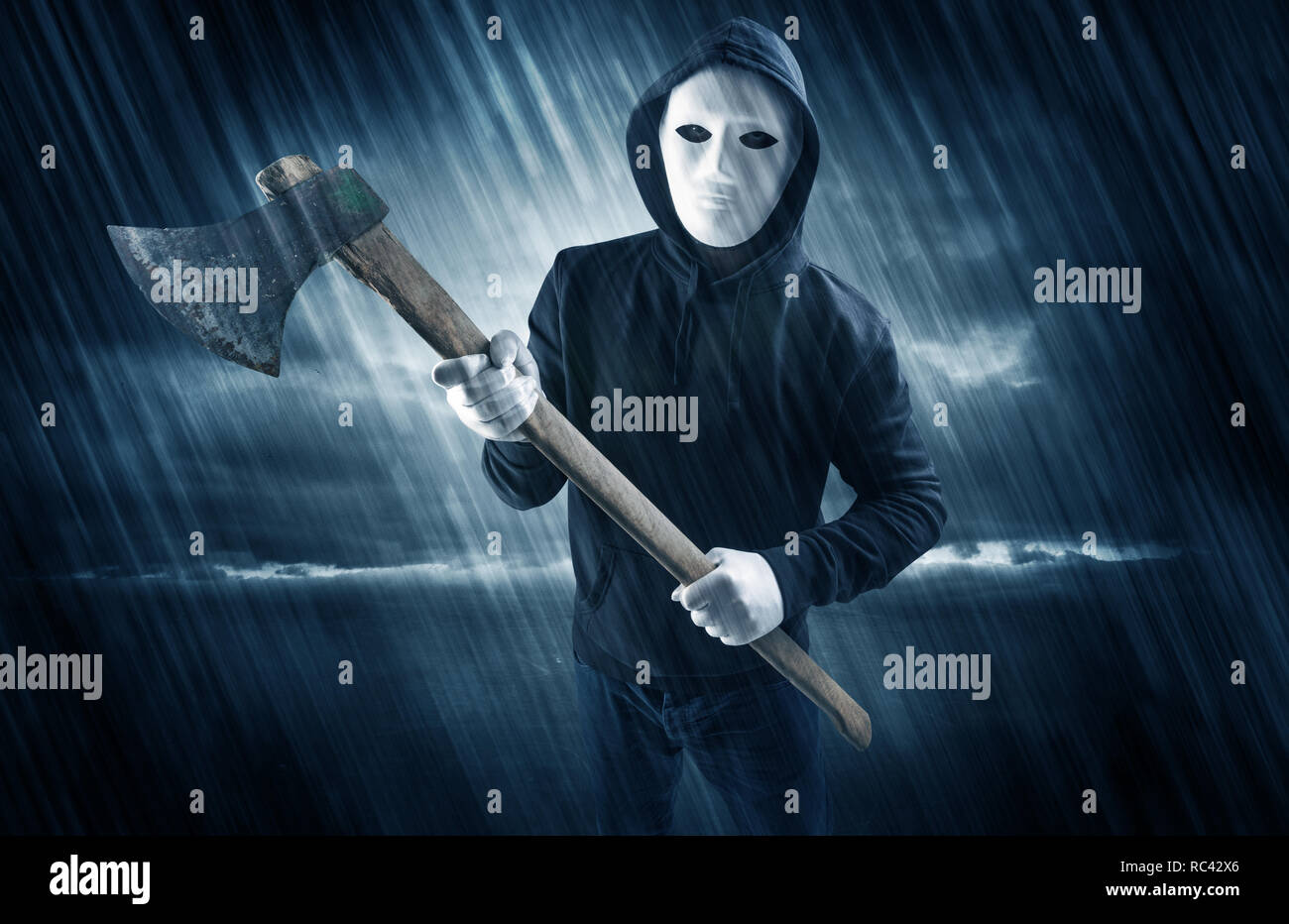 Masked armed poacher in mysterious rainy coastal weather concept Stock ...