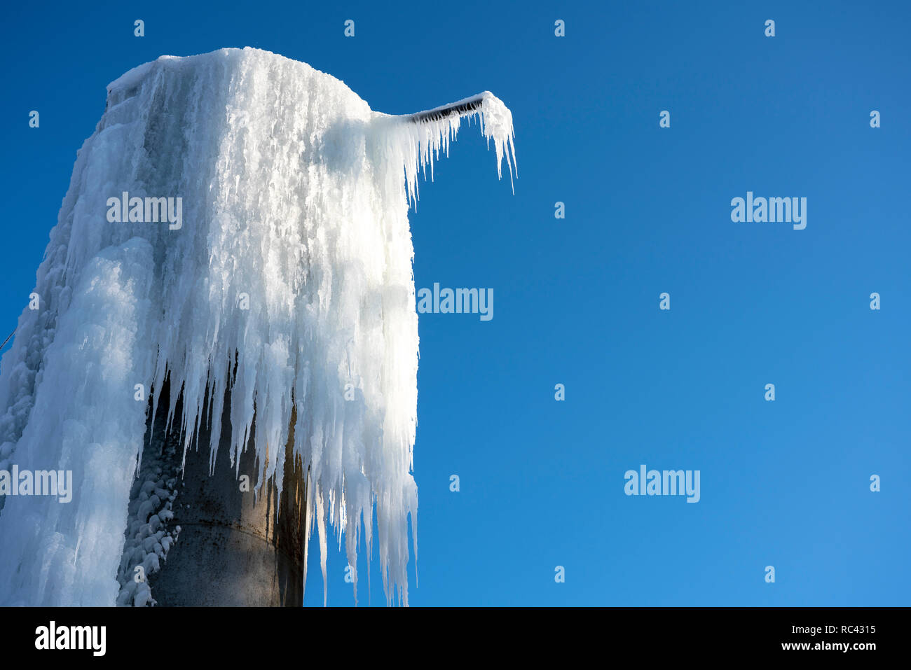 Frozen water tower, hanging huge frozen streams of water Stock Photo ...