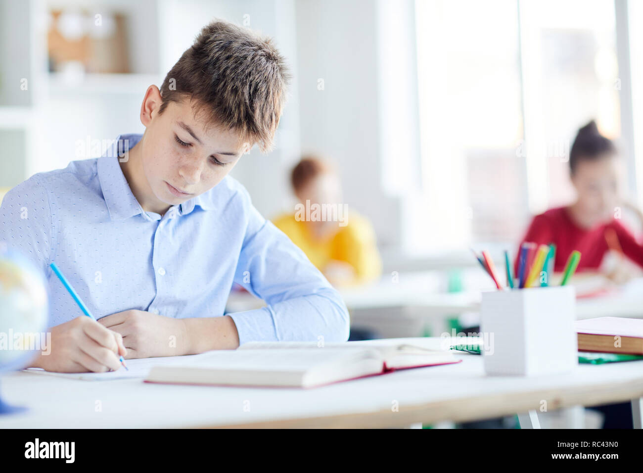 Boy making notes Stock Photo - Alamy