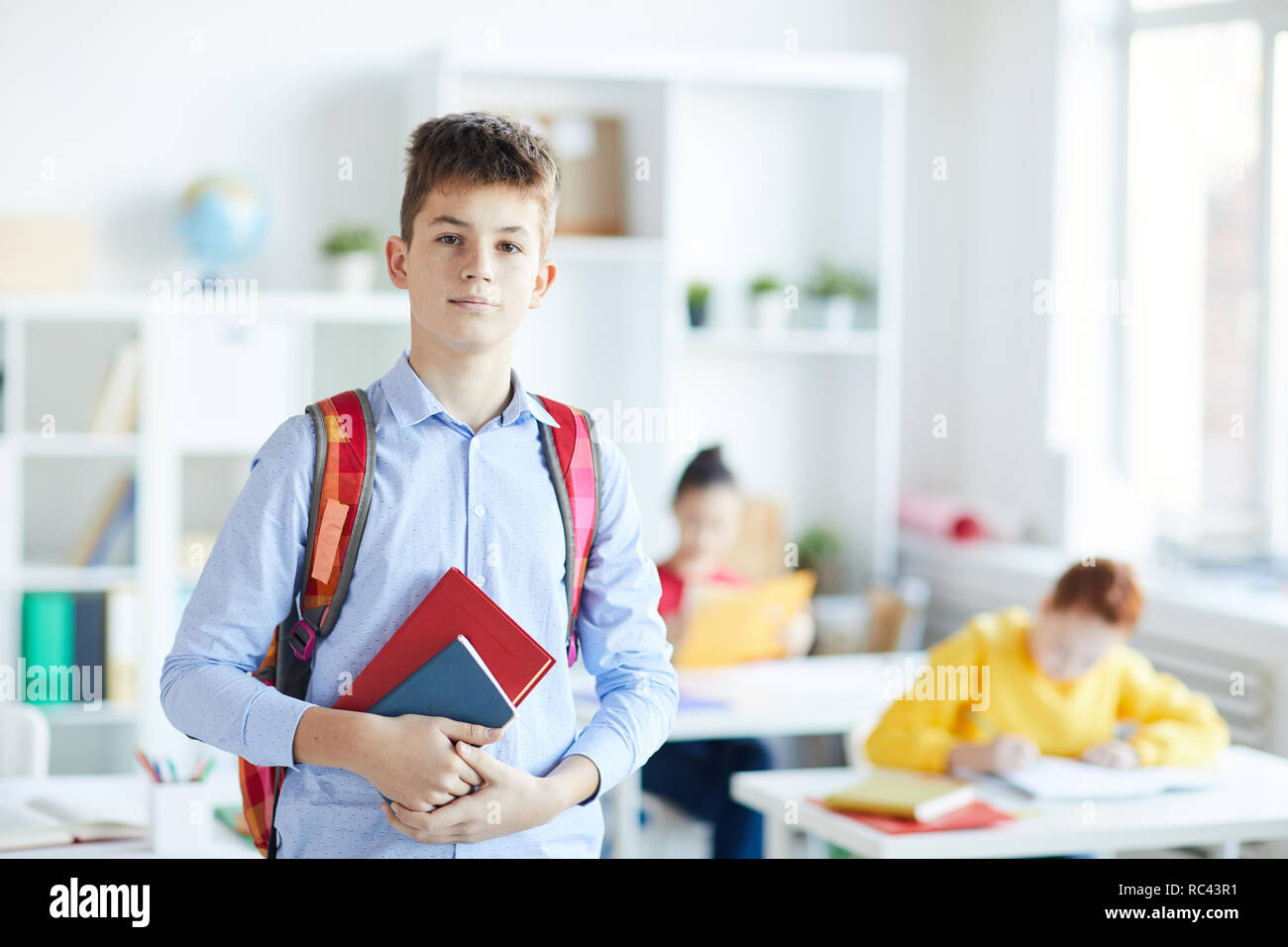 Schoolboy in classroom Stock Photo - Alamy