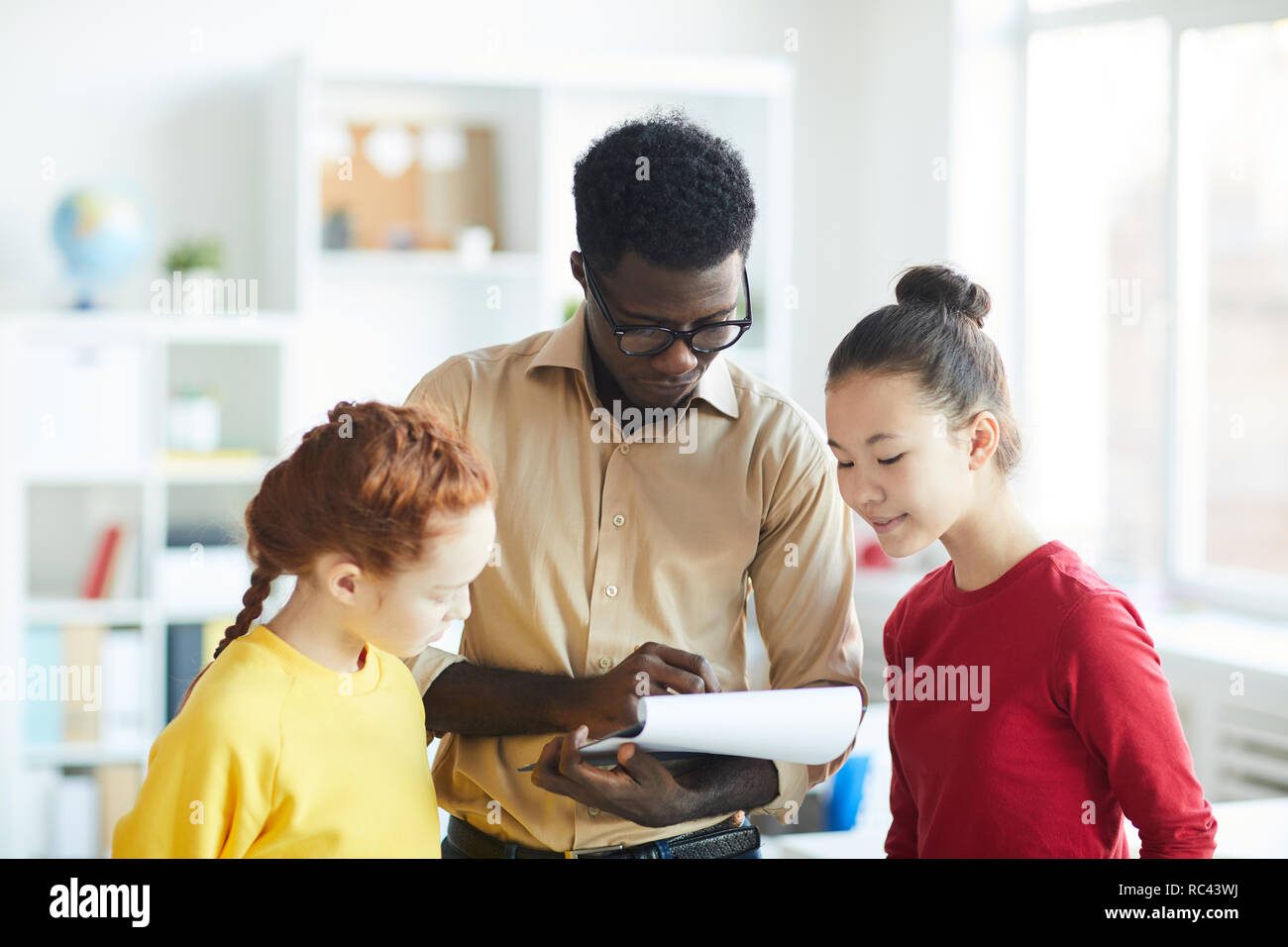 Giving paper to teacher hi-res stock photography and images - Alamy