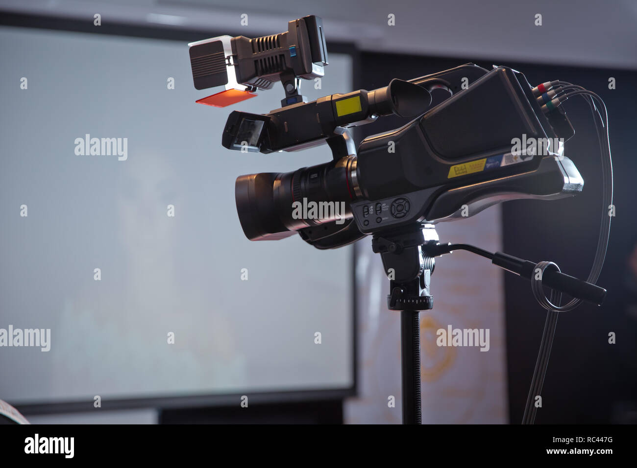Professional digital camera with microphone on the tripod recording ...