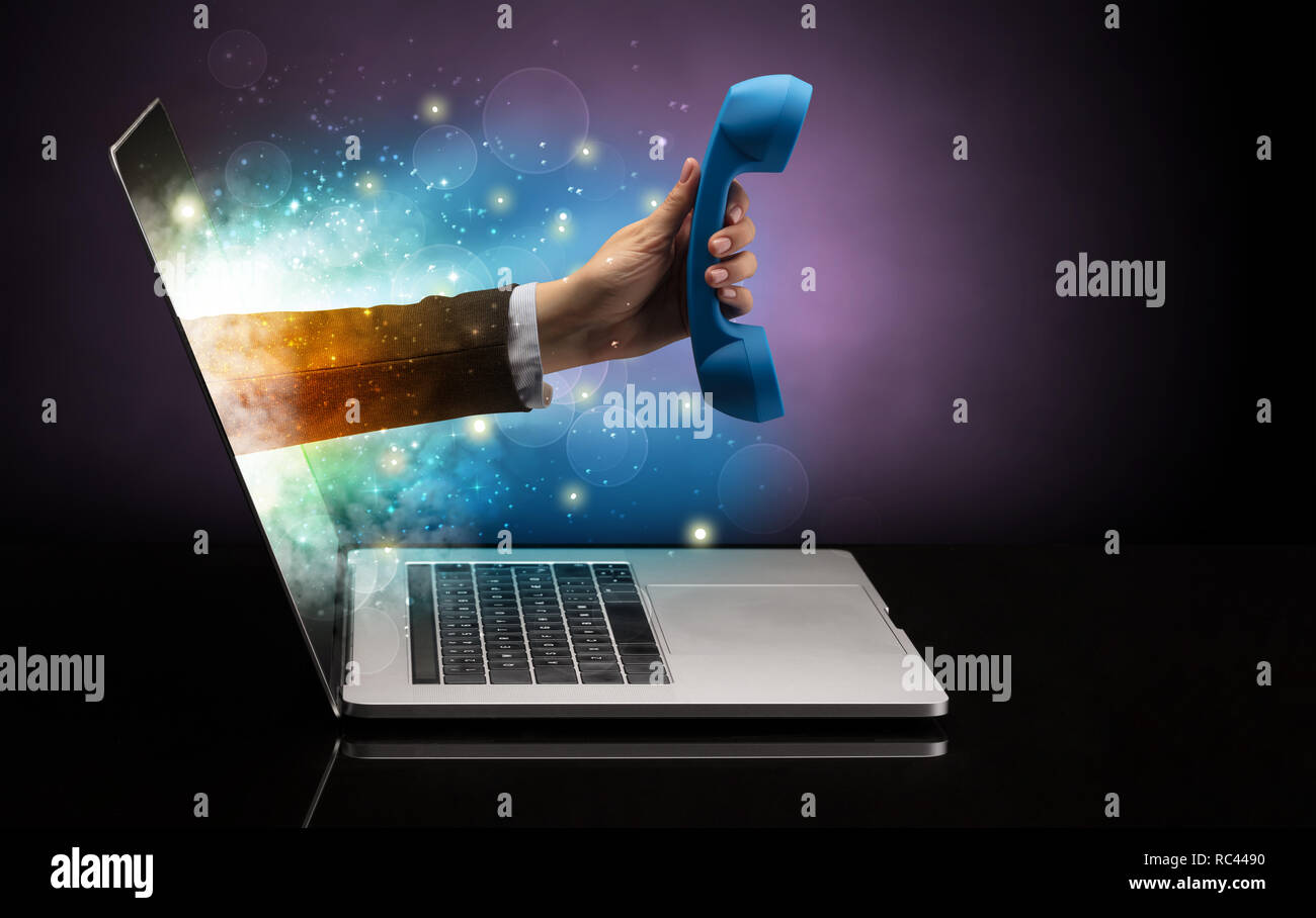 Hand with phone coming out of a laptop with sparkling effects Stock ...