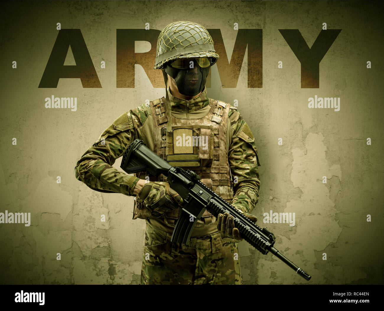 Uniformed armed soldier with damaged wall background Stock Photo - Alamy