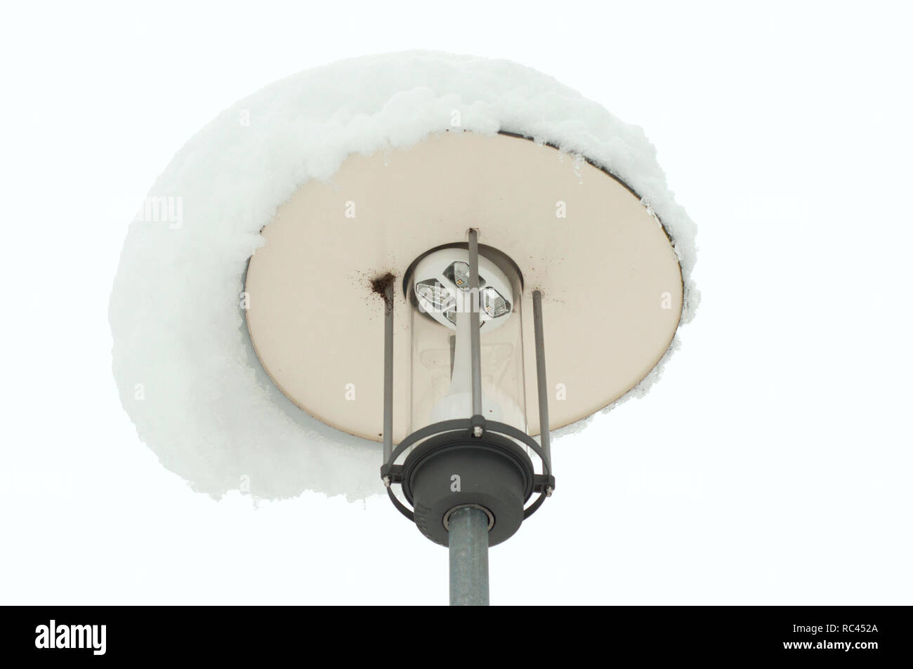 Led street lamp covered with snow isolated on white background. Snowy ...