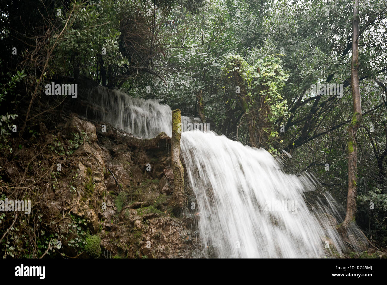 Waterfall flowing from mountain Stock Photo - Alamy