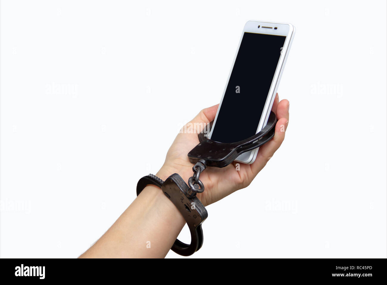 handcuffed hand chained to a smartphone on a white background, female ...