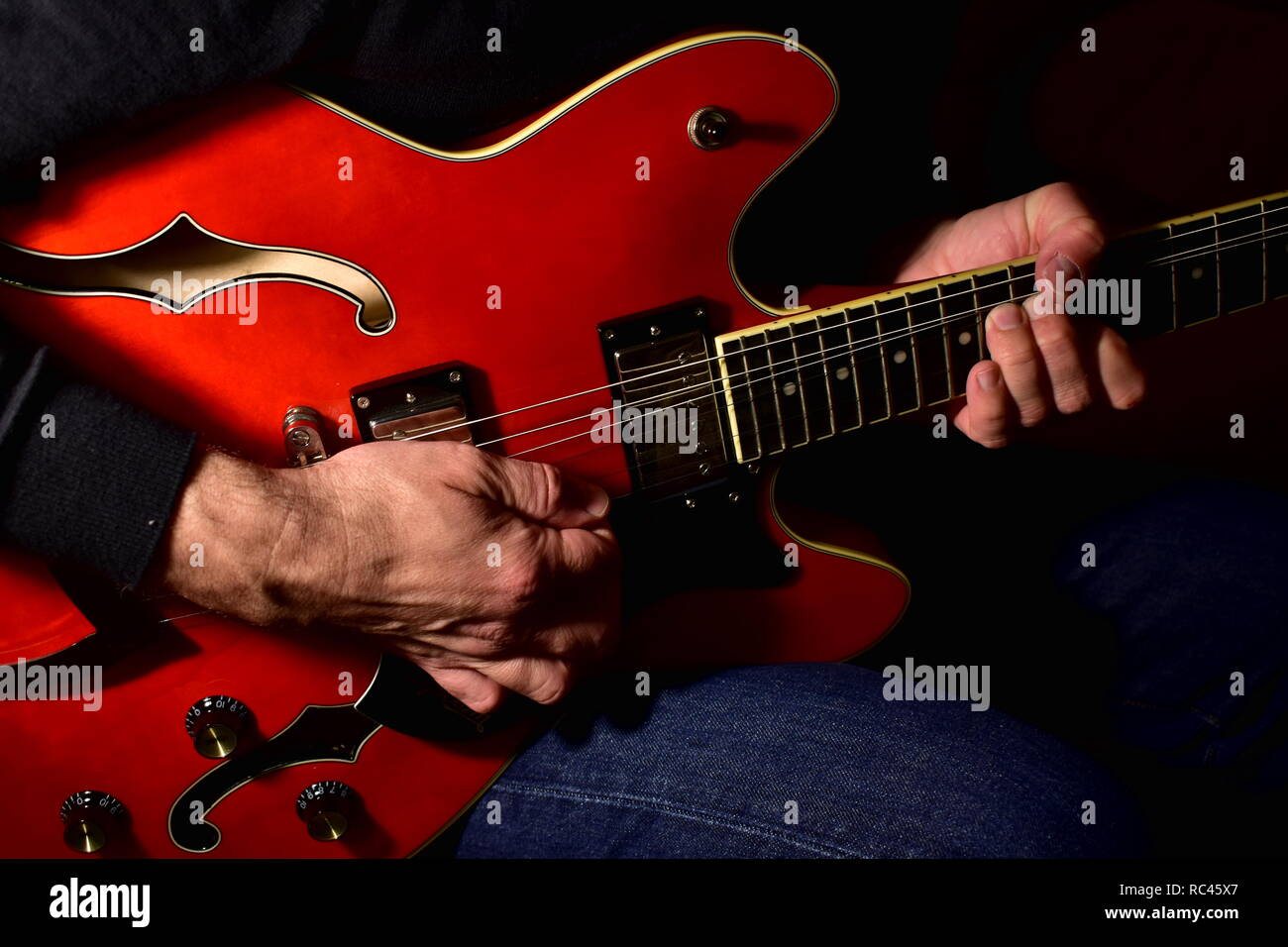 Man playing a electric guitar. Hands closeup, no face, brand or logo ...