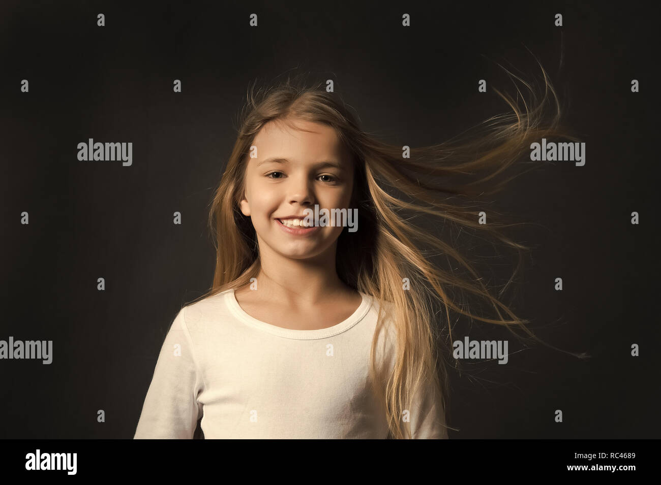 Beauty and hairdressing salon. Girl with adorable smile on dark ...