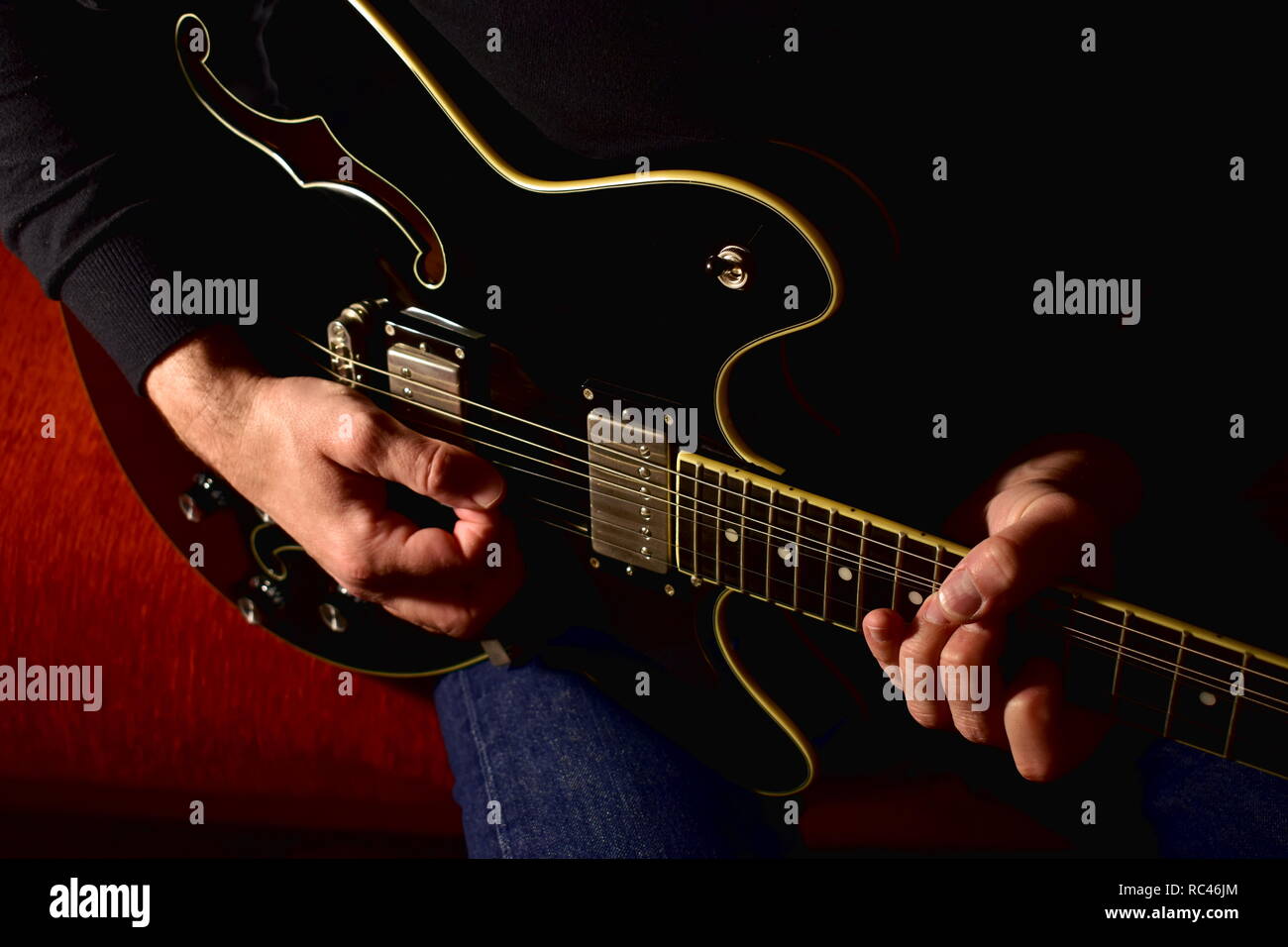Man playing a electric guitar. Hands closeup, no face, brand or logo ...