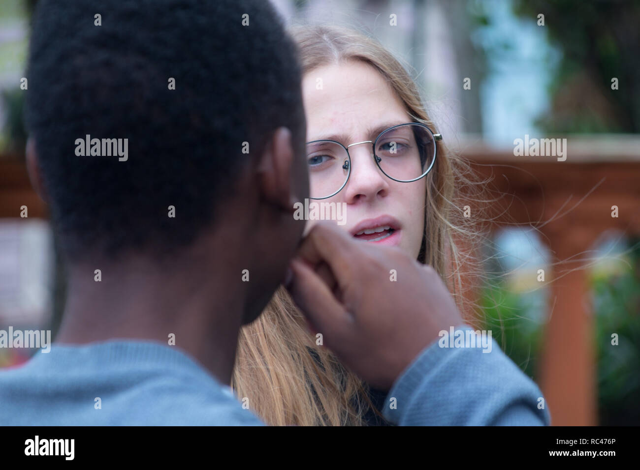 A photo of two students talking to each other in a park Stock Photo - Alamy