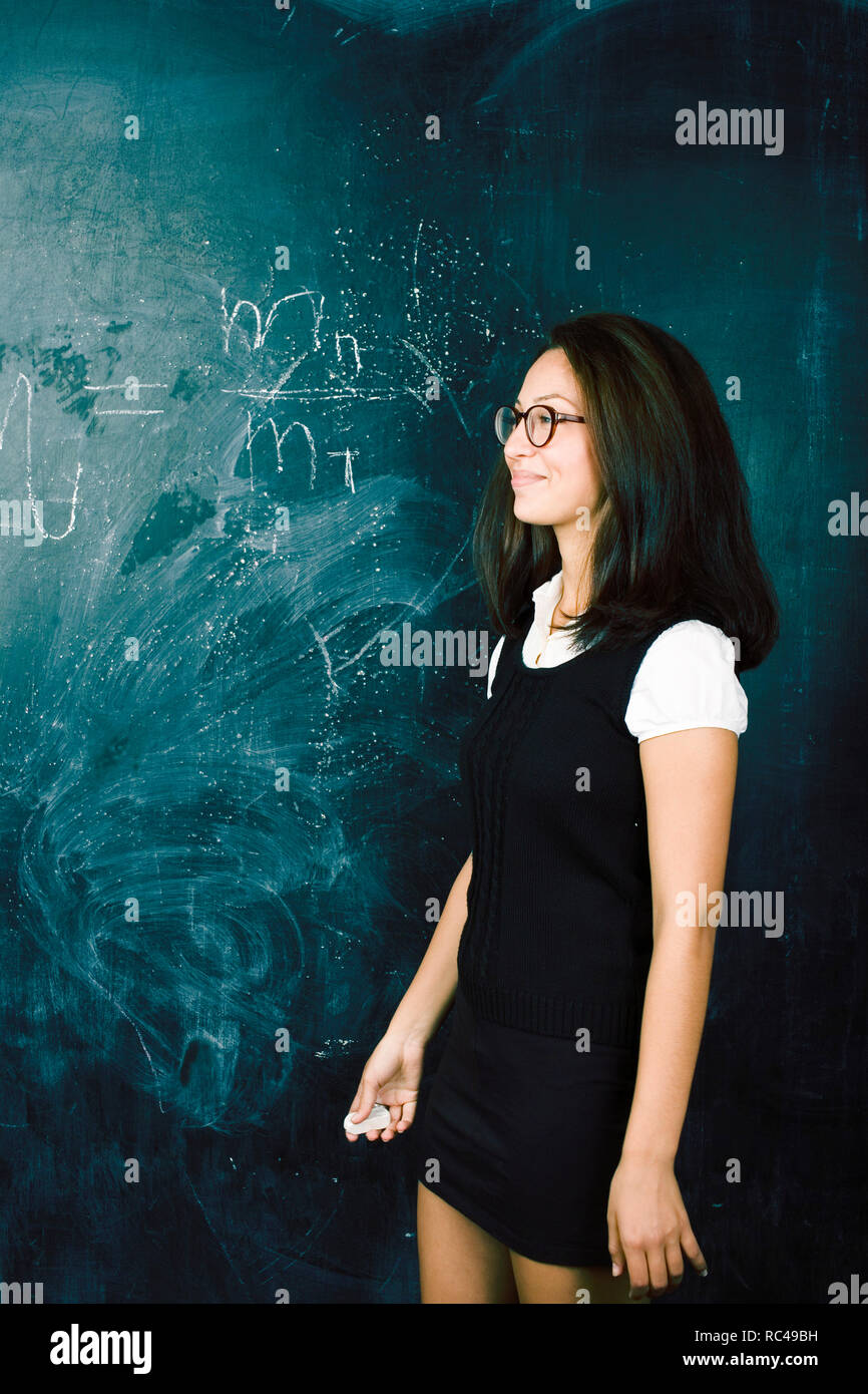portrait of happy cute student in classroom at blackboard back t Stock ...