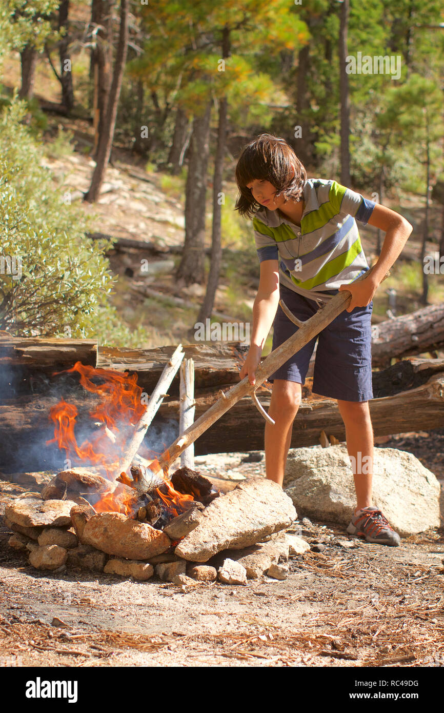 Boy tending a campfire hi-res stock photography and images - Alamy