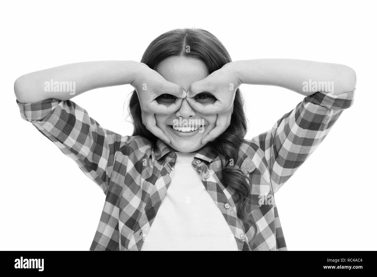 Girl holding fingers near eyes like glasses mask superhero or owl. Play ...