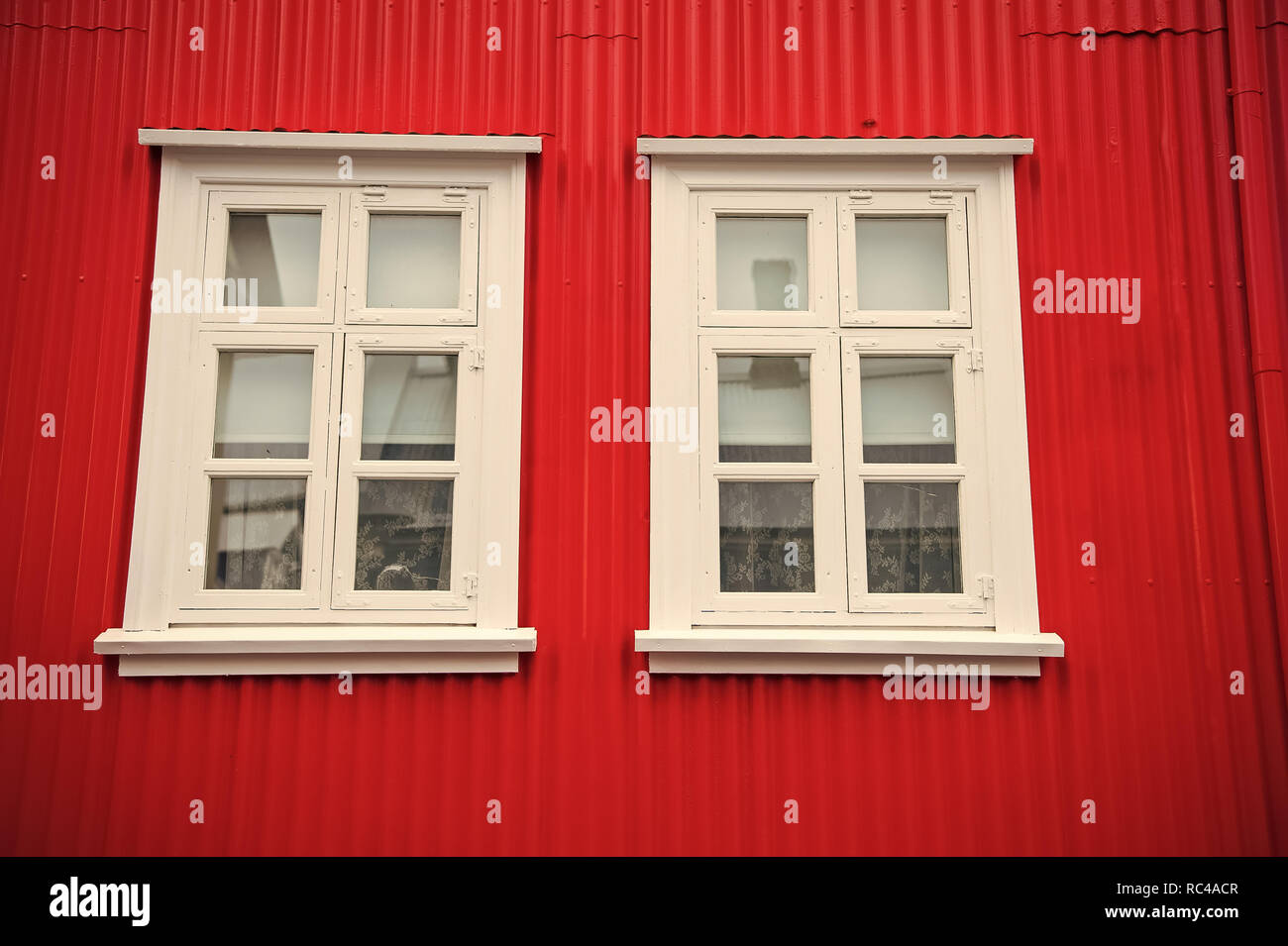 Windows in house in reykjavik, iceland. Building facade with red wall ...