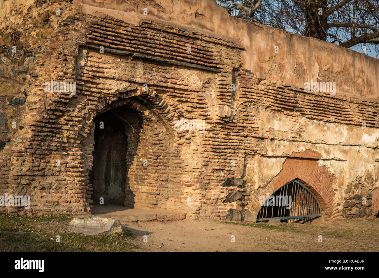 A small arch gate into an abandoned fort in Srinagar, Kashmir. Muslim ...