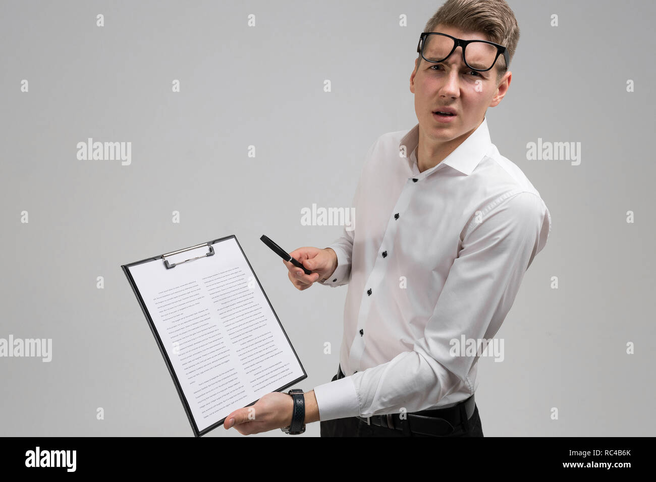 Young man with glasses and insurance questionnaire in hand isolated on ...