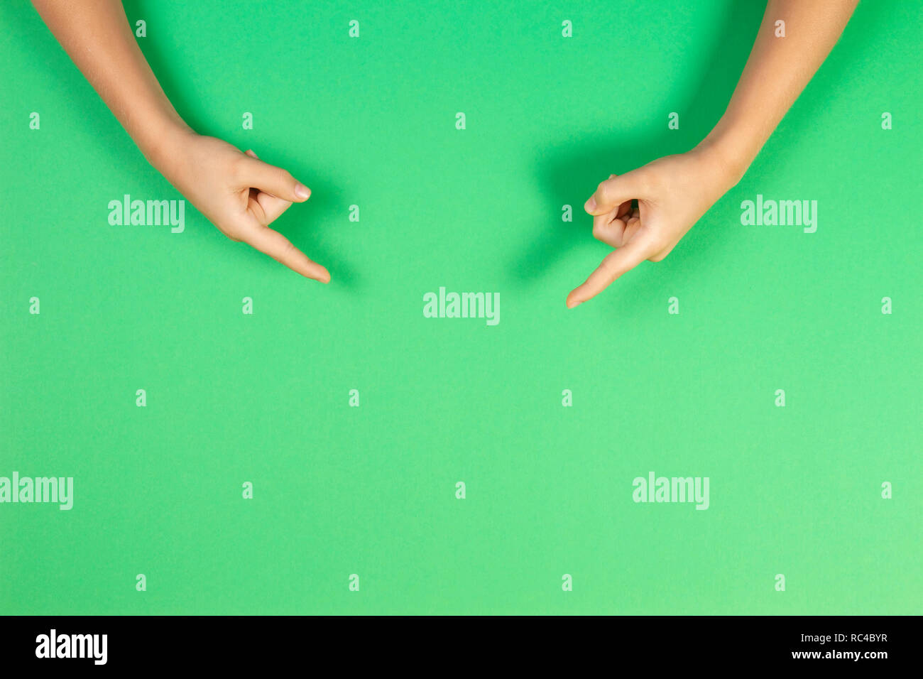 Children hands pointing on pastel green background Stock Photo - Alamy